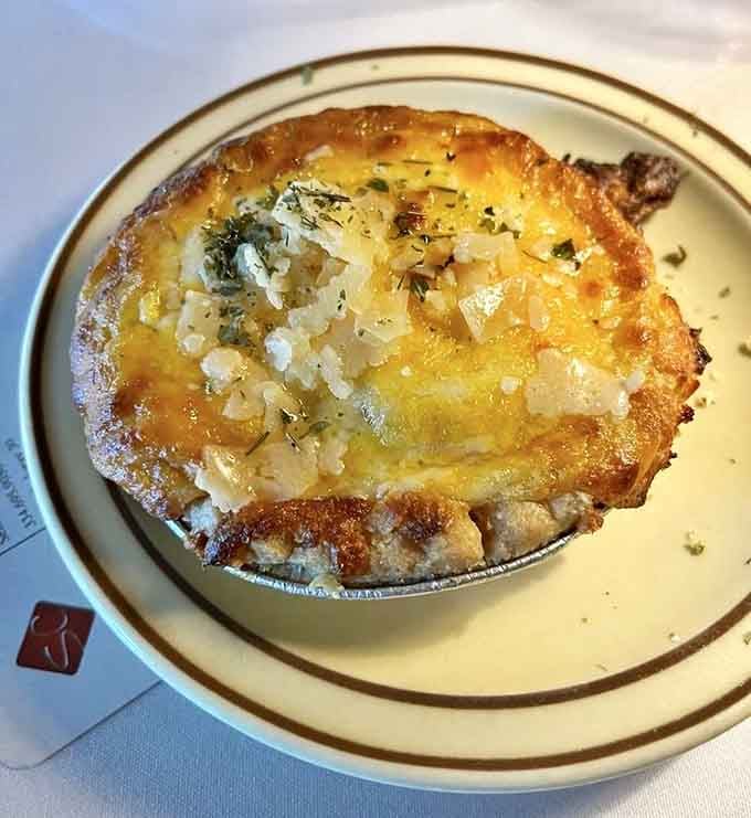 Behold the famous tomato pie, golden and bubbling with cheese, looking like edible sunshine in a crust.