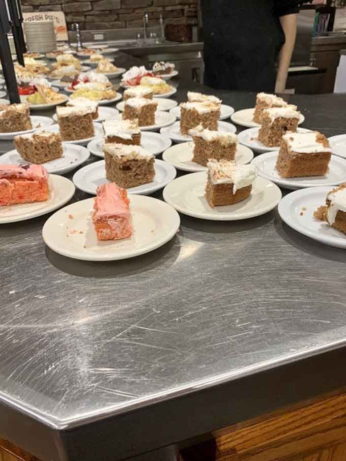 Rows of cake slices await their destiny, each one a different flavor journey begging to be sampled and savored completely.