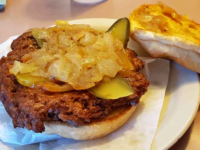 Behold the steakburger with griddled onions and pickles, a masterpiece that makes gourmet burgers look like they're trying too hard.