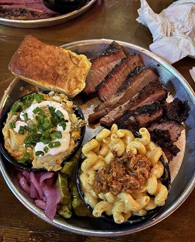 Sliced brisket with that perfect smoke ring sits alongside creamy mac and cheese that could steal the show.