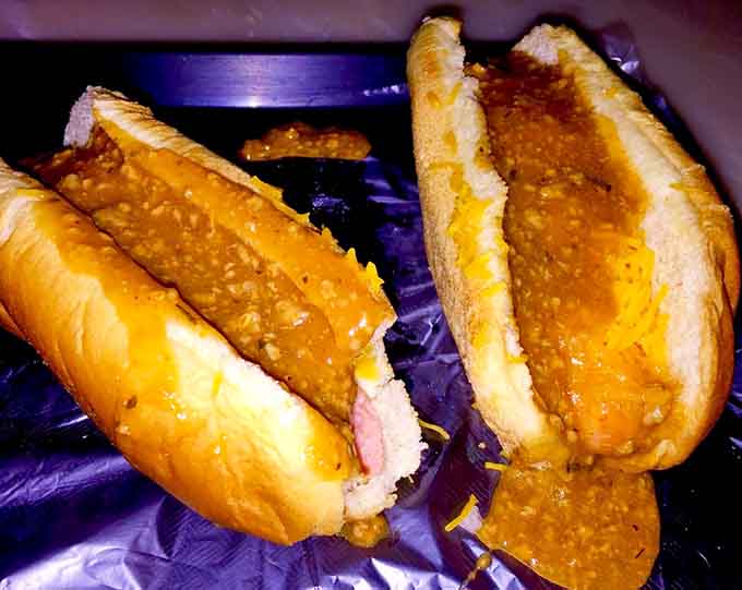 Two chili cheese dogs that look like they've been waiting their whole lives to make you ridiculously happy.