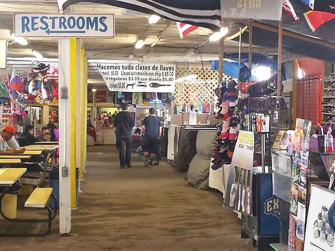 Yellow picnic tables offer weary shoppers a rest stop while flags wave overhead like this market's declaring independence from high prices.