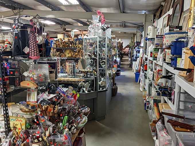 Glass cases and crowded shelves turn this narrow aisle into a fun maze of vintage surprises.
