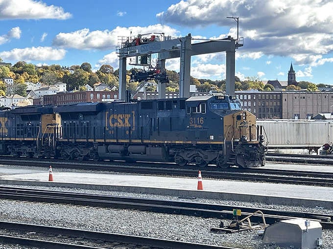 Industrial muscle flexes in the rail yard where massive CSX locomotives rest between cross-country journeys hauling America's goods.
