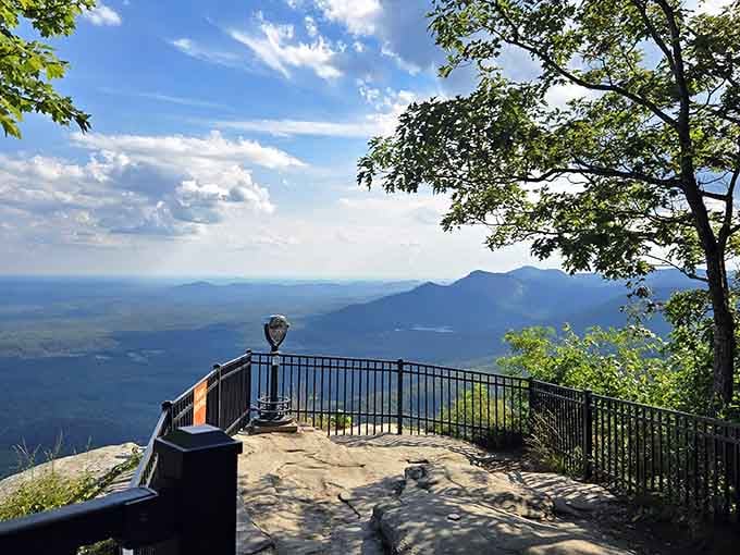 Mountain ridges fade into the distance like watercolor brushstrokes, stretching endlessly beneath that impossibly blue sky.