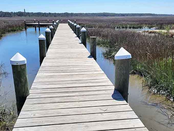 This weathered boardwalk stretches toward endless marshland, inviting you to walk into the wild blue yonder.