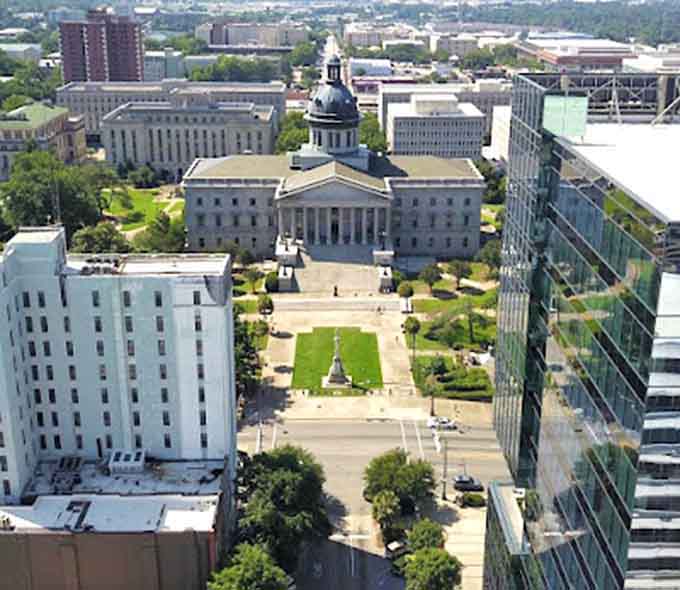 The State House dome gleams like a copper penny while manicured lawns stretch out in perfect symmetry below.