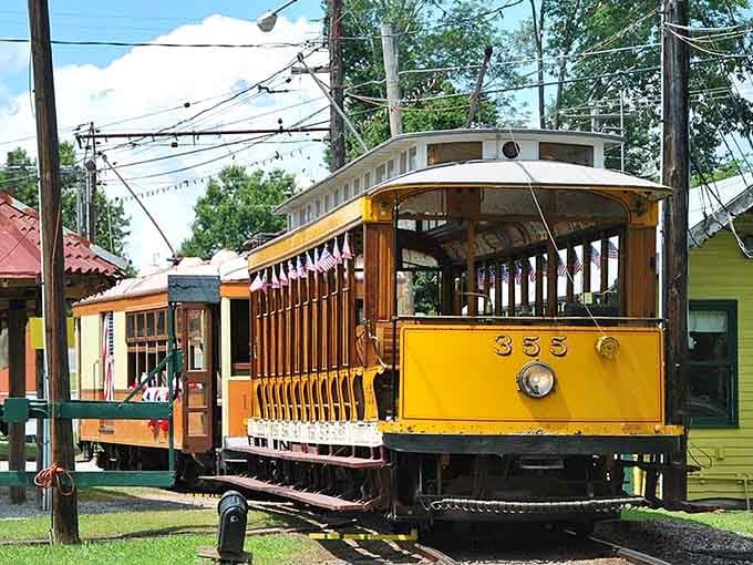 Trolley number 355 gleams in golden yellow, its open-air design perfect for catching summer breezes on scenic rides.