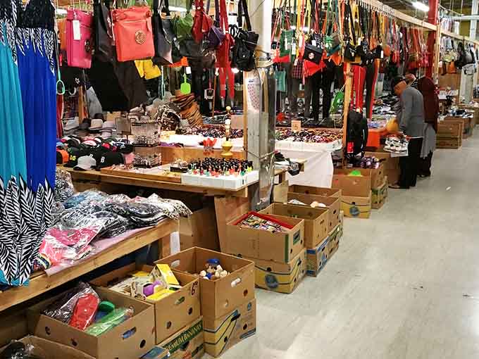 Colorful purses dangle like a rainbow above tables packed with jewelry, shoes, and accessories in this indoor wonderland.