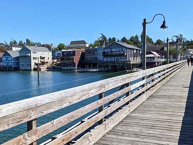 The wooden pier stretches toward colorful waterfront homes that look like they're floating on Liberty Bay.