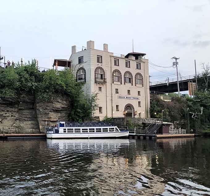 Rising from the riverbank like something from a noir film, this weathered building watches over the water with silent intensity.
