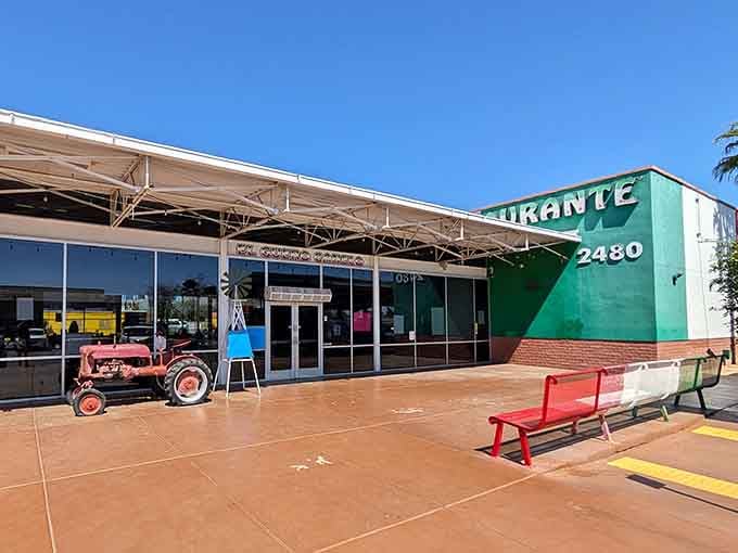 The vintage tractor parked outside adds quirky charm while bacon-wrapped hot dogs work their magic inside this colorful spot.