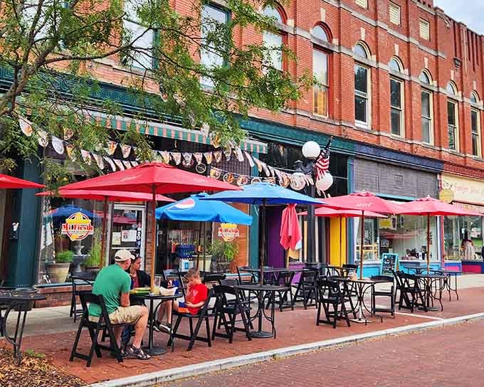 Outdoor dining under cheerful umbrellas transforms an ordinary Tuesday into a celebration worth savoring with friends.