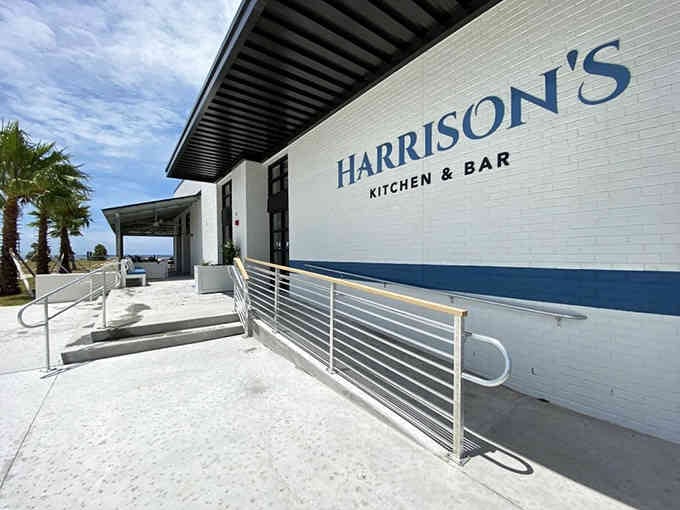 Modern waterfront dining with palm trees swaying nearby feels like winning the location lottery, doesn't it?