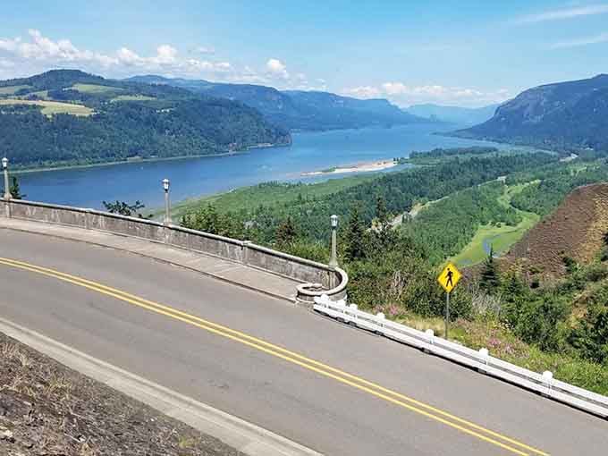 The Columbia River sparkles below this engineering marvel, where every curve reveals another reason to pull over.