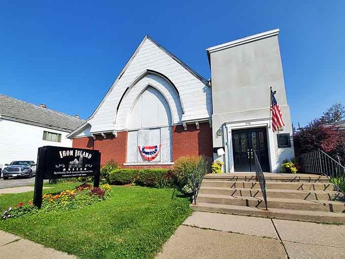 That soaring white arch against blue sky proves even former churches can have mysterious second acts in life.
