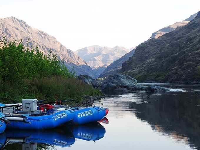 Blue rafts rest peacefully beside canyon walls, promising adventures that would make even Indiana Jones a bit jealous.