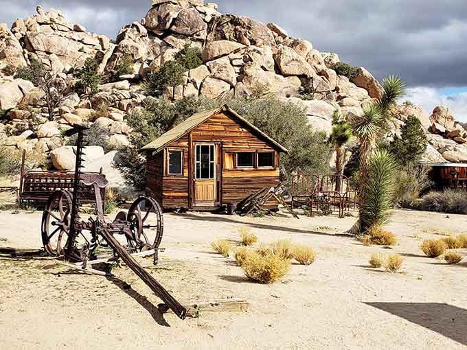 That weathered cabin against dramatic boulders looks like a movie set from every classic Western you remember.