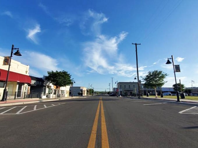 Wide open streets under impossibly blue skies make this downtown feel spacious and welcoming, perfect for leisurely strolls and window shopping.