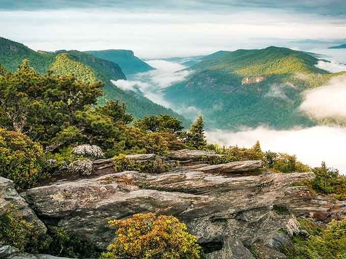 Clouds drift through ancient valleys like cotton candy in a geological candy store that's been millions of years in the making.