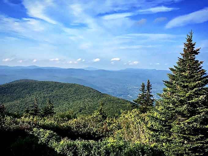 Mountain ridges layer into the distance under brilliant blue skies, creating nature's version of a Bob Ross painting.