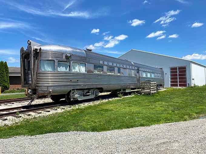This sleek silver passenger car gleams in the sunlight, embodying the elegance of mid-century American rail travel.