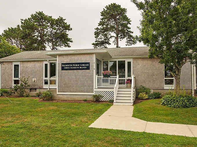 Classic Cape Cod shingles and a welcoming porch make this library the neighborhood's cozy reading retreat.