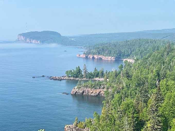 Misty morning light reveals islands scattered across the water like a painter's careful brushstrokes.