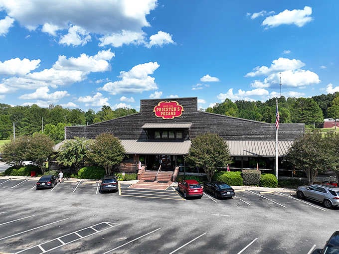 The rustic wooden building with its bold red sign has been a landmark for travelers seeking authentic pecan goodness.