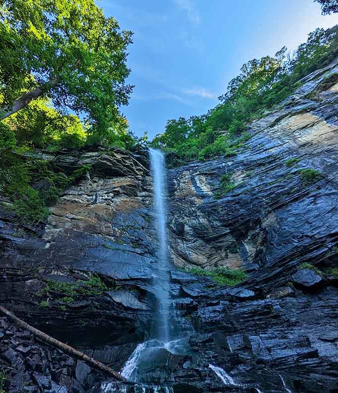 Rainbow Falls cascades down layered rock like nature's own fountain, tucked away in a green cathedral of stone.