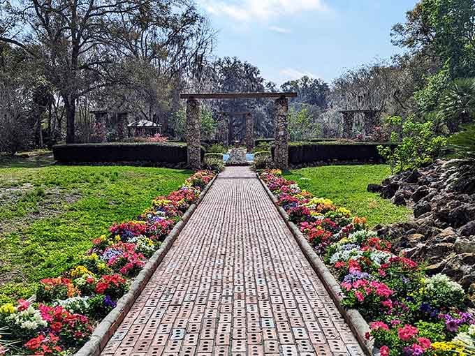 This brick pathway lined with spring blooms leads you through gardens that would make Monet reach for his brushes.
