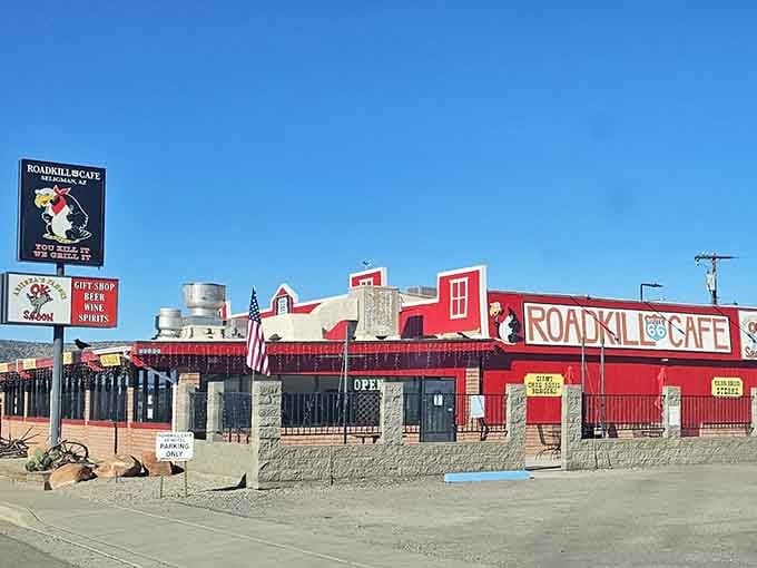 Bright red buildings and rustic charm line this stretch where the Old West meets quirky roadside humor.