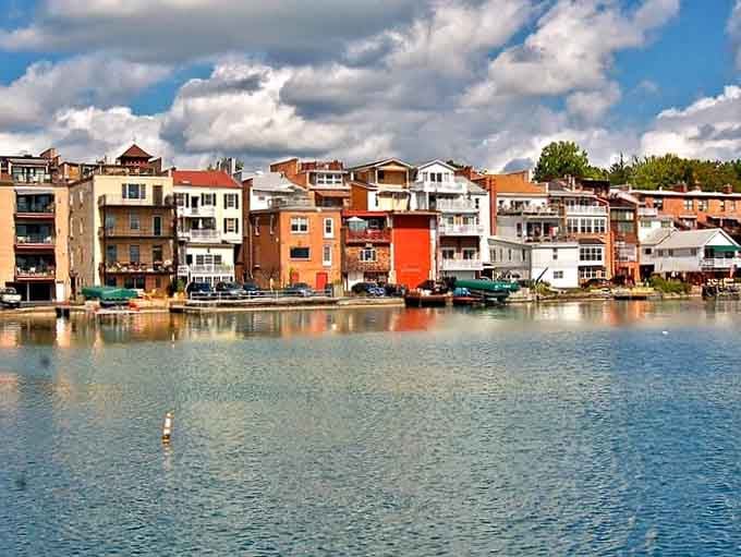 Colorful waterfront homes cluster together like a box of crayons spilled along the peaceful lake's reflective surface.