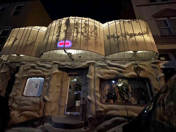 That glowing canopy and sculpted rock entrance suggest you're about to dine in Middle Earth's coziest cavern.