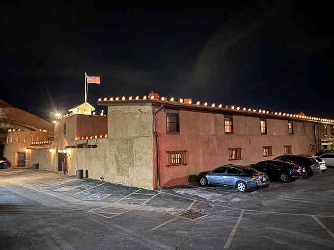 Adobe walls glow under evening lights, standing proud like a sentinel from frontier days past.