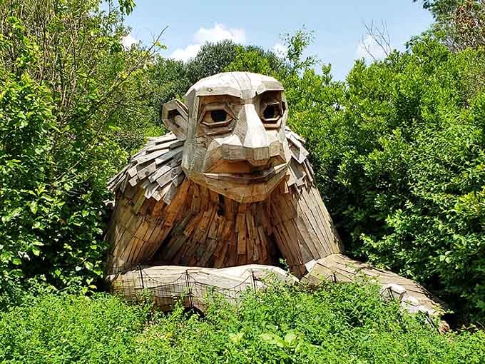 This gentle giant wooden owl watches over visitors with wise eyes, like a forest guardian straight out of a childhood fairy tale.