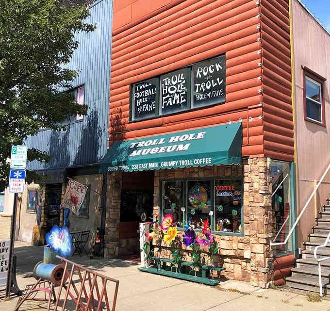 The orange cabin exterior practically glows with whimsy, inviting you into a world where trolls reign supreme and nostalgia rules.