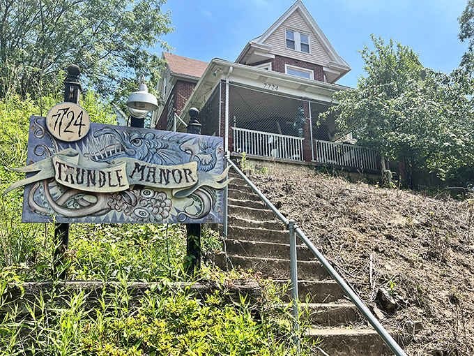 That hand-painted sign promises curiosities within, and those stairs suggest you'll earn every delightfully weird moment ahead.