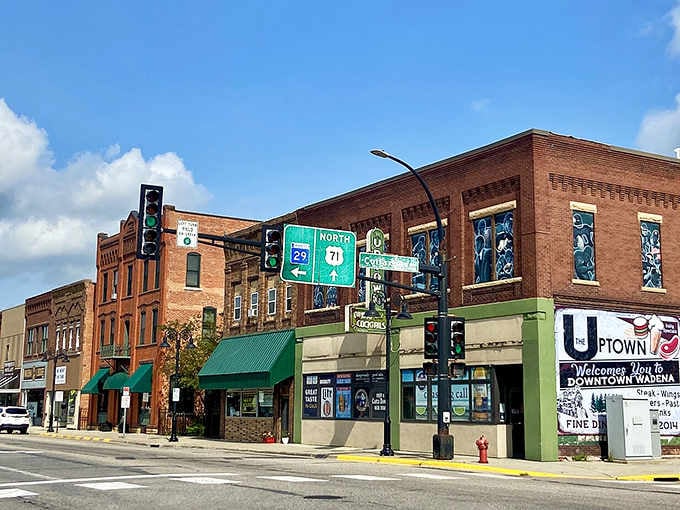 Those green awnings and brick facades create a welcoming downtown where every shop feels like a neighborhood gathering spot.
