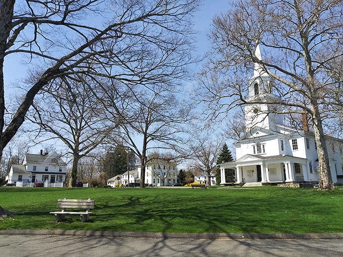 That white church steeple rising through bare branches could grace any New England postcard collection.