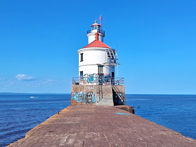 Standing at the pier's end like a chess piece guarding the harbor, this white beauty commands respect from every passing vessel.