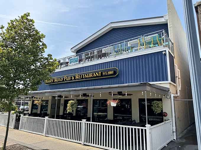 The blue corrugated siding and white railings create a beachside vibe that screams "vacation mode activated immediately."
