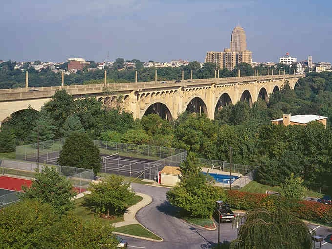 The classic stone bridge arches over greenery, connecting past and present in one elegant Pennsylvania sweep.