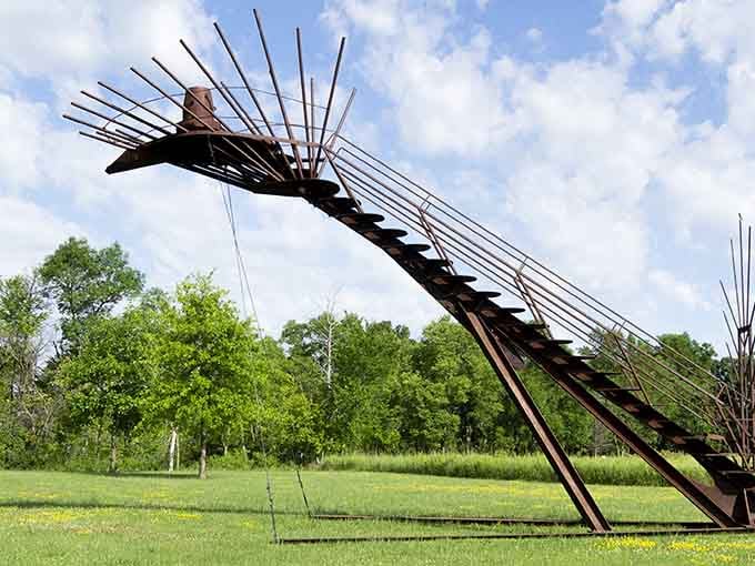 Dramatic metal wings sweep skyward, capturing motion and grace in weathered steel that tells stories.