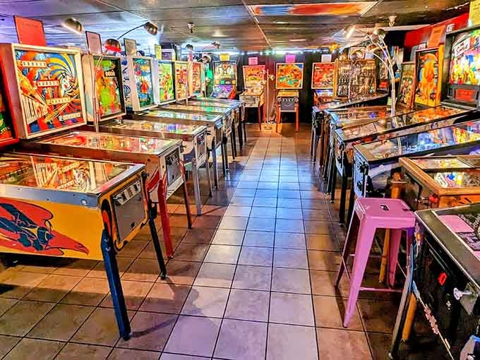 Rows of vintage pinball machines stand ready like colorful soldiers, each one offering bells, bumpers, and pure analog entertainment.