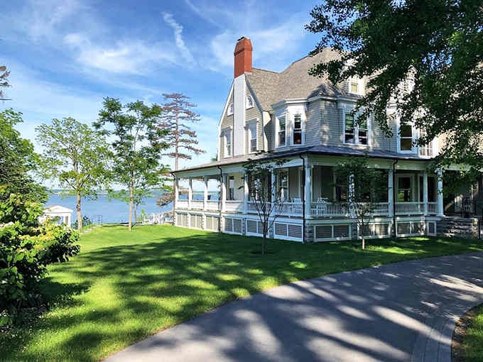 That wraparound porch overlooks the lake, offering views that make you wonder why anyone invented television in the first place.