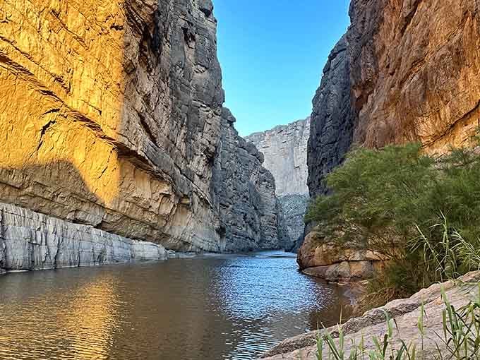 Limestone cliffs rise dramatically overhead, their striped layers telling stories older than any history book could capture.