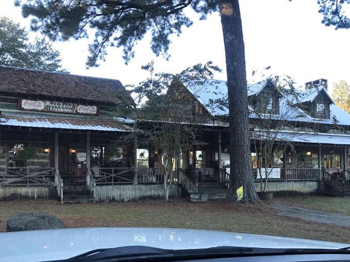 The weathered wood and sprawling porch create an authentic Old West atmosphere that's pure dinner theater magic.