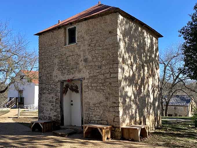 That limestone building with its shaded doorway whispers stories of European settlers who built to last generations.