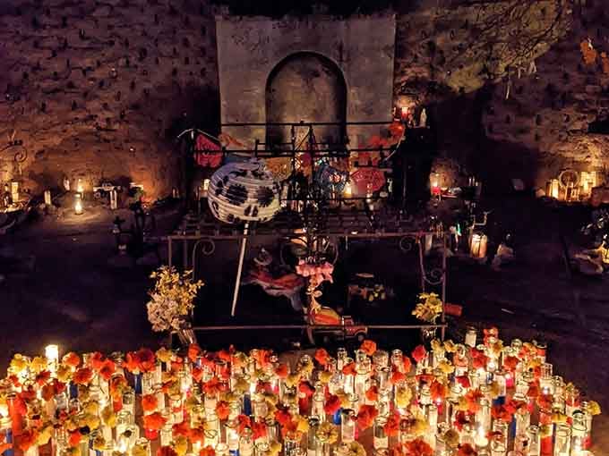 The candlelit shrine creates an almost magical scene where wishes and prayers mingle with the warm desert night air.